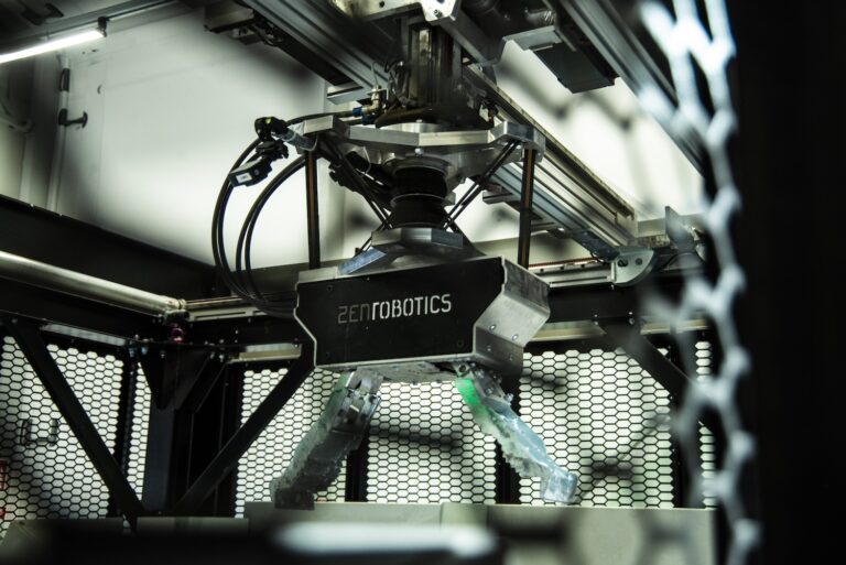 4._View_of_a_ZenRobotics_Heavy_Picker_robotic_arm_through_a_safety_cage ...
